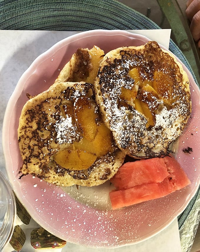 These peach pancakes aren't just breakfast&mdash;they're morning therapy. The dusting of powdered sugar is like fresh snow on a perfect landscape.
