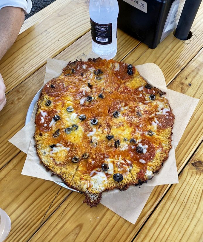 Their fried cheese pizza defies physics and good sense in the best possible way. The crispy cheese perimeter is worth fighting over.
