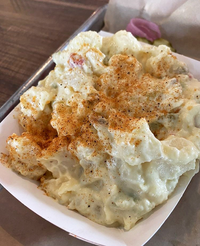 Not your grandmother's potato salad (unless your grandmother was secretly a culinary genius). This creamy side dish knows its role: supporting the meat while stealing scenes.