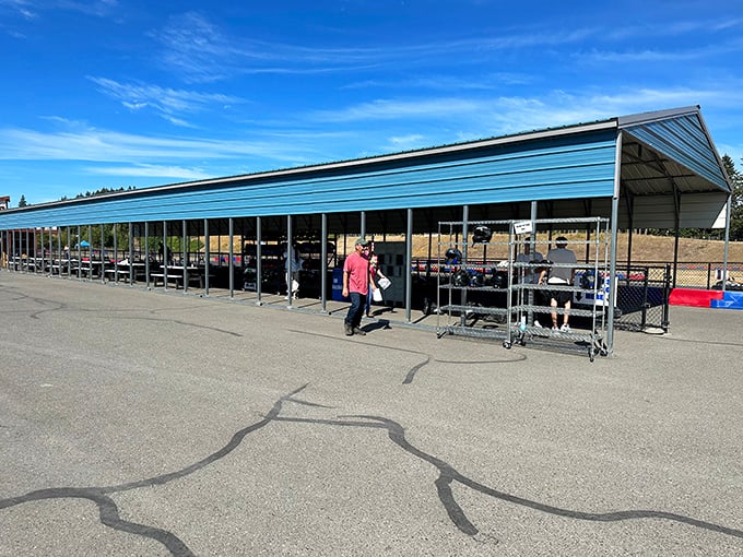 Race control tower stands sentinel over the track, while nearby, helmets await their next adventure like soldiers ready for battle.
