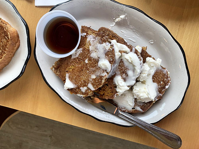 Pumpkin bread transformed into French toast with maple syrup and butter &ndash; autumn's greatest contribution to breakfast, available whenever you need comfort on a plate.