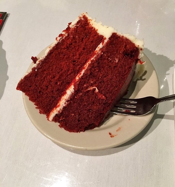 Red velvet cake so vibrant it should come with sunglasses, layered with cream cheese frosting that's worth every joyful calorie.