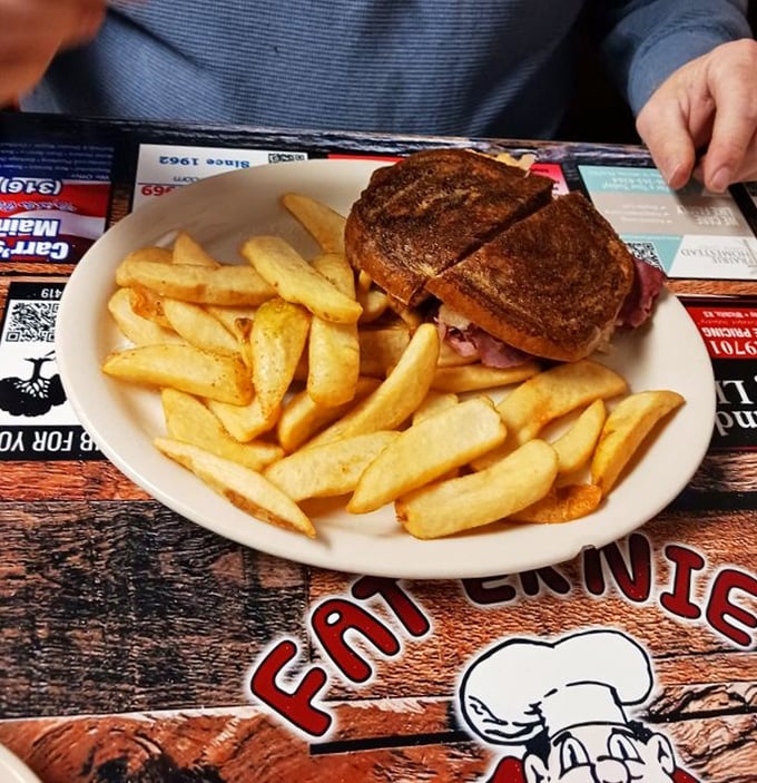 A proper Reuben doesn't need to show off. It just sits there, perfectly grilled, surrounded by golden fries, silently judging lesser sandwiches.