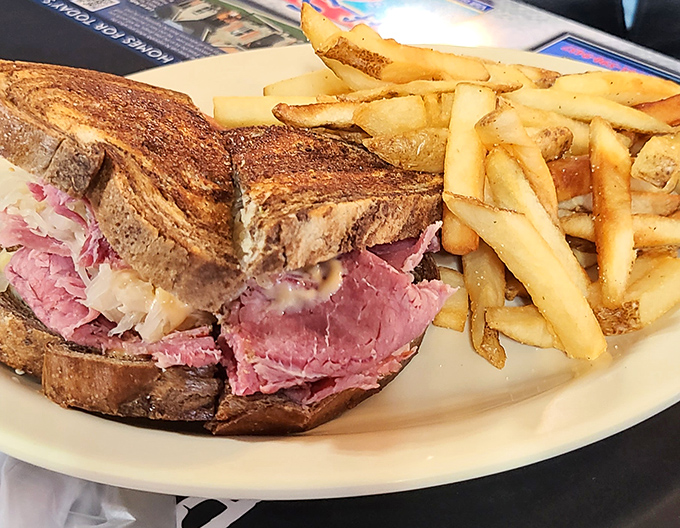 The Reuben sandwich&mdash;a towering achievement of pink perfection. That's not just a sandwich; it's architecture you can eat, with fries as the support beams.