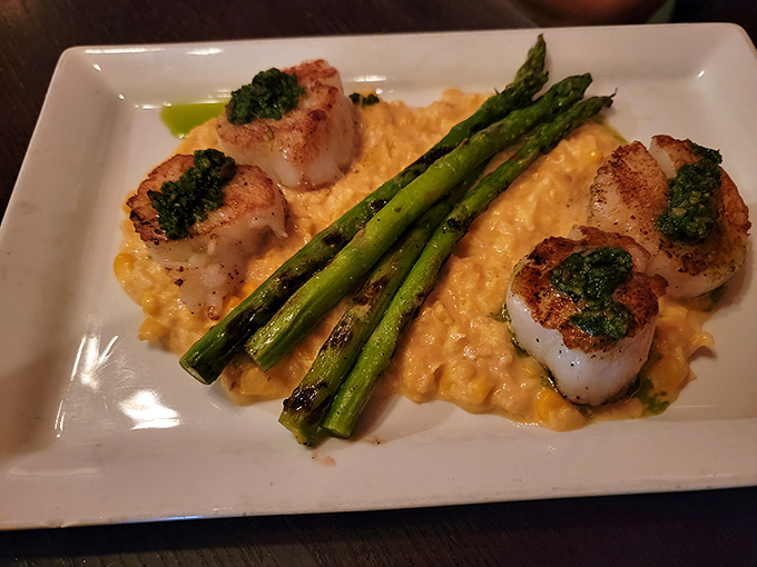 These seared scallops nestled on creamy risotto with asparagus make seafood lovers question their loyalty to steak, if only for one magnificent meal.