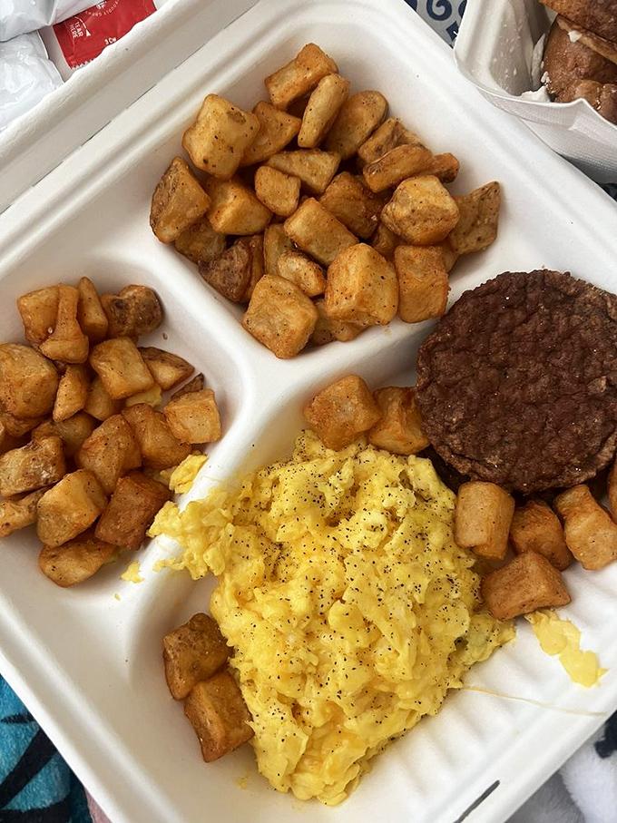 Home fries surrounding scrambled eggs and sausage&mdash;the breakfast trinity that's been making mornings bearable since time immemorial.