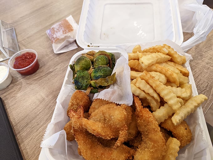A basket of golden shrimp and fries that makes you wonder why fancy restaurants bother with plates. Sometimes, paper-lined simplicity just wins.