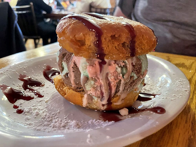 The dessert equivalent of architectural genius: ice cream sandwiched between donut halves with a drizzle of sauce that defies gravity and diets alike.