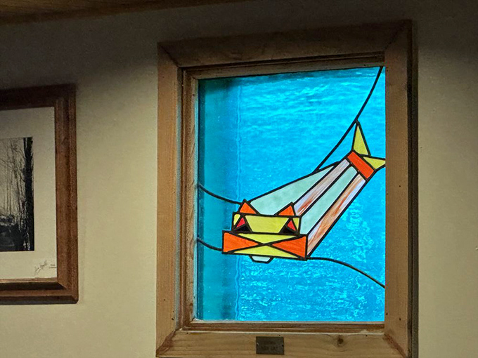 Even the stained glass celebrates fishing&mdash;a whimsical catfish swimming through blue waters, capturing the restaurant's playful spirit.