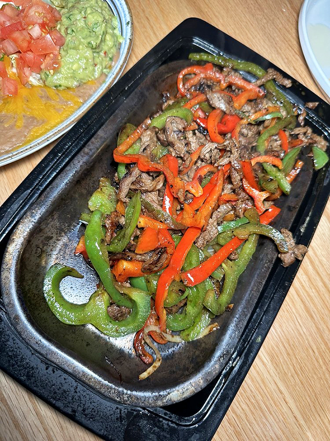 Sizzling fajitas with a rainbow of peppers that would make a bell pepper farmer weep with pride. This isn't dinner&mdash;it's a joyful commotion on a plate.