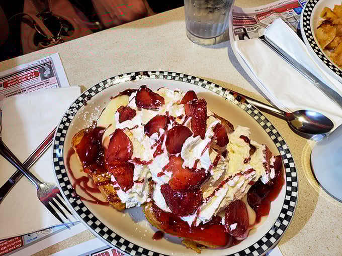 Strawberry-stuffed French toast that makes you question why regular toast even exists, topped with enough whipped cream to make a cloud jealous.