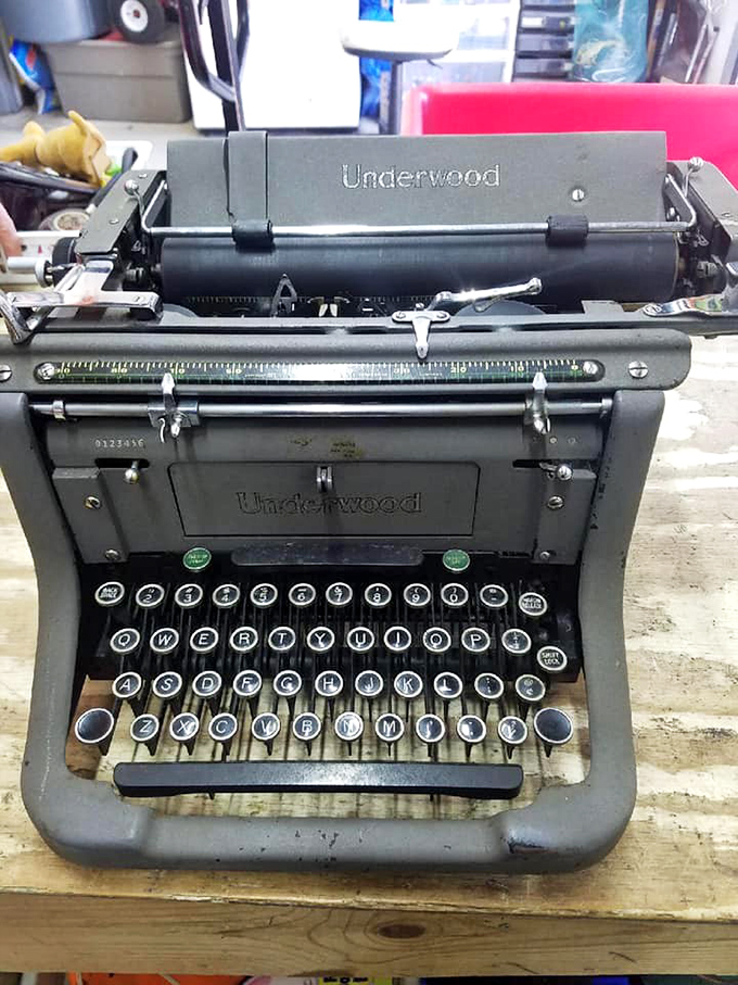 An Underwood typewriter stands ready to tell new stories, a mechanical relic from when writing was a commitment, not just a deleted text.