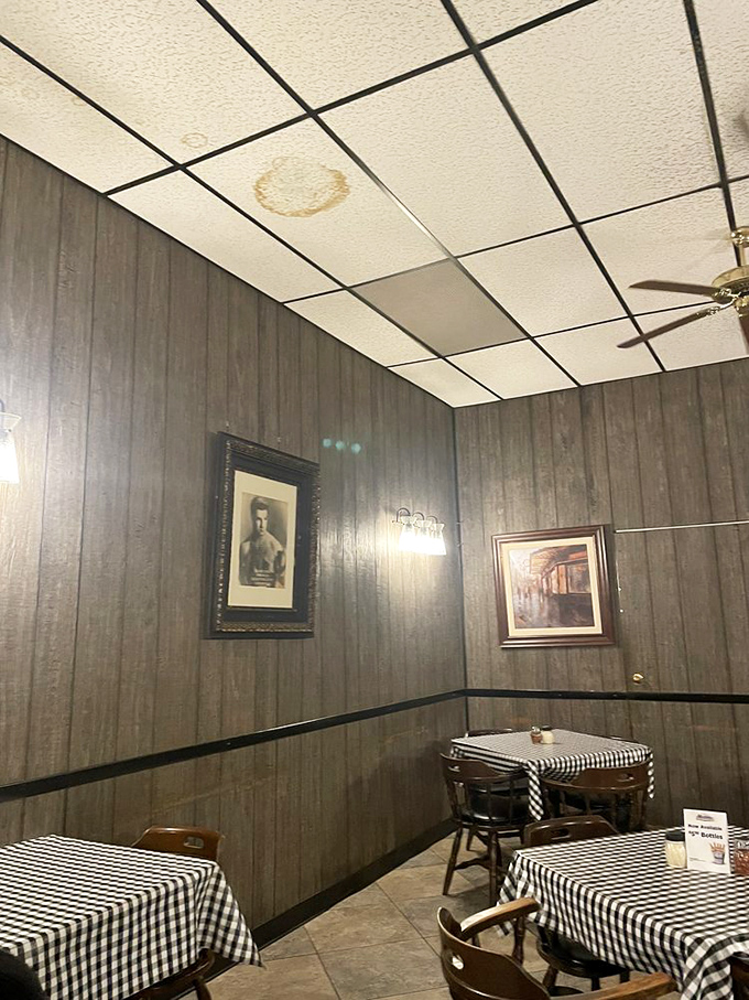 Wood paneling and framed art create dining nooks that feel frozen in time. This isn't retro&mdash;it's a place that never needed to change.