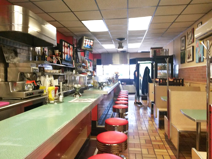 The counter view at G&A&mdash;where strangers become neighbors and regulars become family, all united by the universal language of good food.