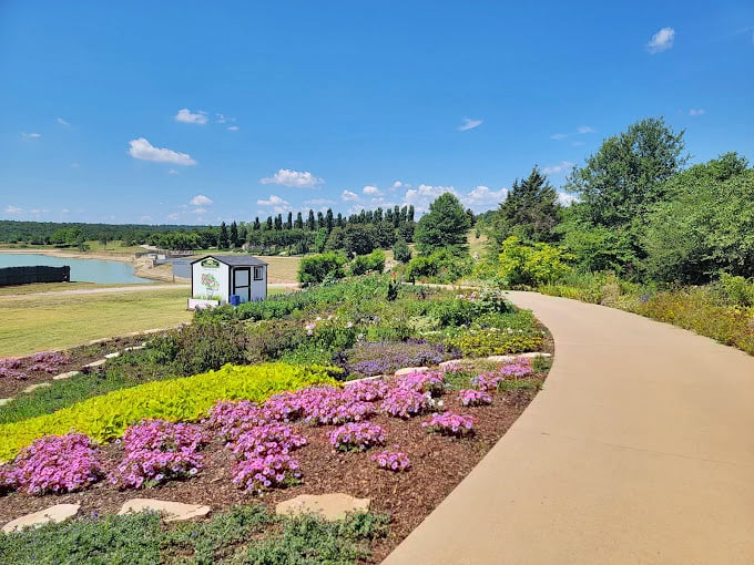 Winding paths lead through carefully curated color explosions, proving that in Oklahoma, even the walkways are works of art.