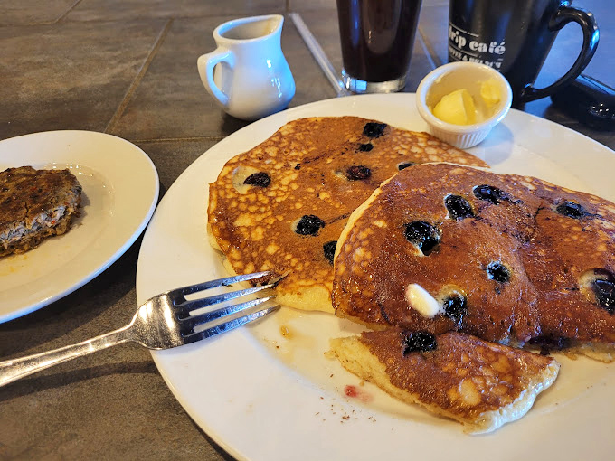 Blueberry pancakes that make you wonder why you ever considered a smoothie bowl. The fork stands ready for its noble purpose.