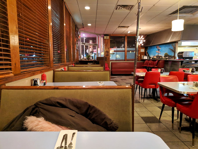 Evening at Lucky's brings a different energy. Those wooden blinds have filtered the sunset for generations of diners seeking comfort.