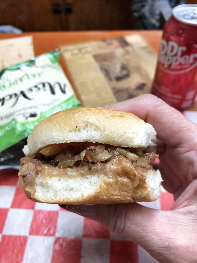 The cross-section reveals the truth: caramelized onions melded with beef on a pillowy bun. Simplicity that's survived a century for good reason.