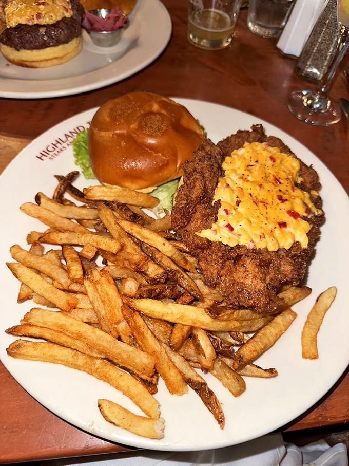 A burger that demands to be photographed before eaten. The golden fries are the perfect supporting cast for this cheesy masterpiece.