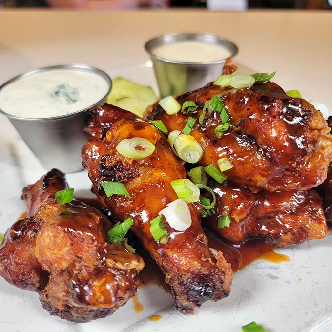 Wings glazed to sticky, glistening perfection. The green onion garnish isn't fooling anyone &ndash; there's nothing remotely healthy about this delicious indulgence.