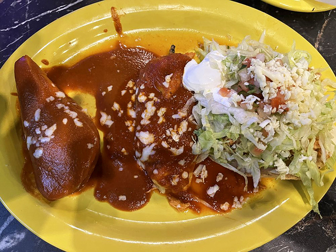 Enchiladas swimming in a rich red sauce &ndash; like lifeguards in a tomato sea. The cheese on top practically winks at you.
