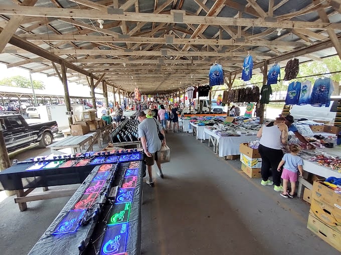 The market's covered walkways create a bazaar-like atmosphere where vintage clothing hangs alongside modern merchandise. The perfect spot for people-watching between purchases.