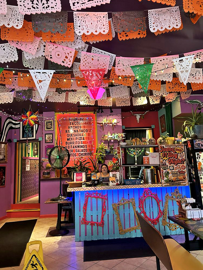 The counter glows blue beneath vintage-inspired frames, while psychedelic wall art swirls behind. It's like dining inside a Frida Kahlo painting that's been remixed by a DJ.