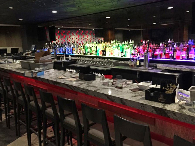 This isn't just a bar counter&mdash;it's a rainbow-lit stage where cocktails are born under the watchful gaze of bottles standing at attention.