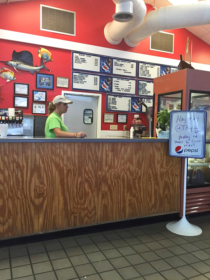 Behind this wooden counter, seafood magic happens daily. The menu board overhead reads like a greatest hits album of comfort food.