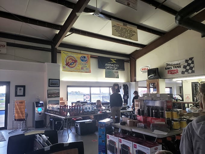 The pro shop: half racing supply store, half church of speed. Where everyday citizens plot their transformation into weekend warriors.