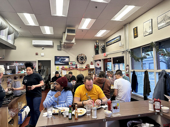 The morning congregation at Fuller's&mdash;where strangers become temporary neighbors over coffee that never stops flowing.