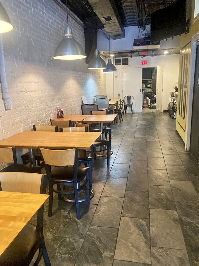 Modern minimalism meets seafood sanctuary in this dining area, where the industrial pendant lights spotlight the only thing that matters: your meal.