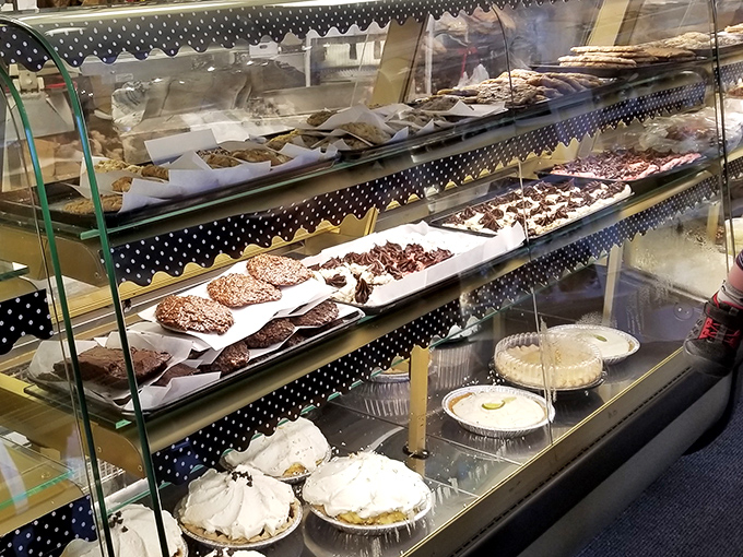 A display case that belongs in the Louvre. Every shelf tells a story of flour, butter, and sugar transformed into edible art.