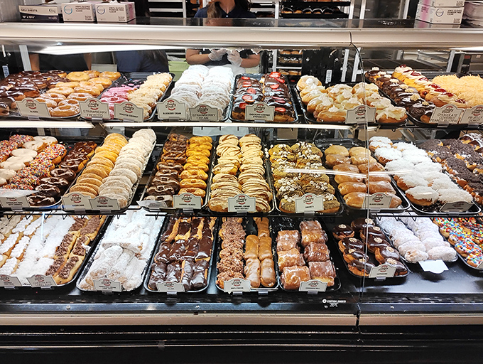 Pastry cases that should come with a warning: "Decisions made here may result in immediate joy and delayed regret." Sweet geometry in perfect rows.