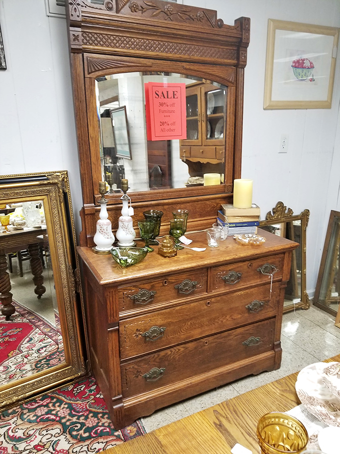 This isn't just furniture; it's a dignified oak dresser with mirror that has witnessed a century of human vanity and morning routines.