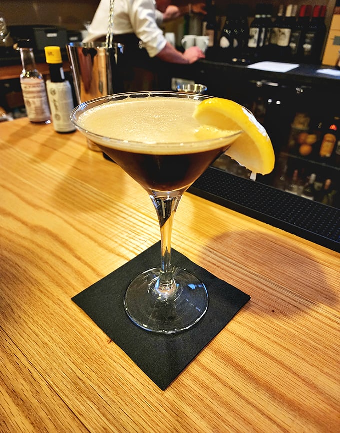 This isn't just a cocktail; it's liquid sophistication with a twist of lemon, sitting pretty on a bar that's seen its share of celebrations.