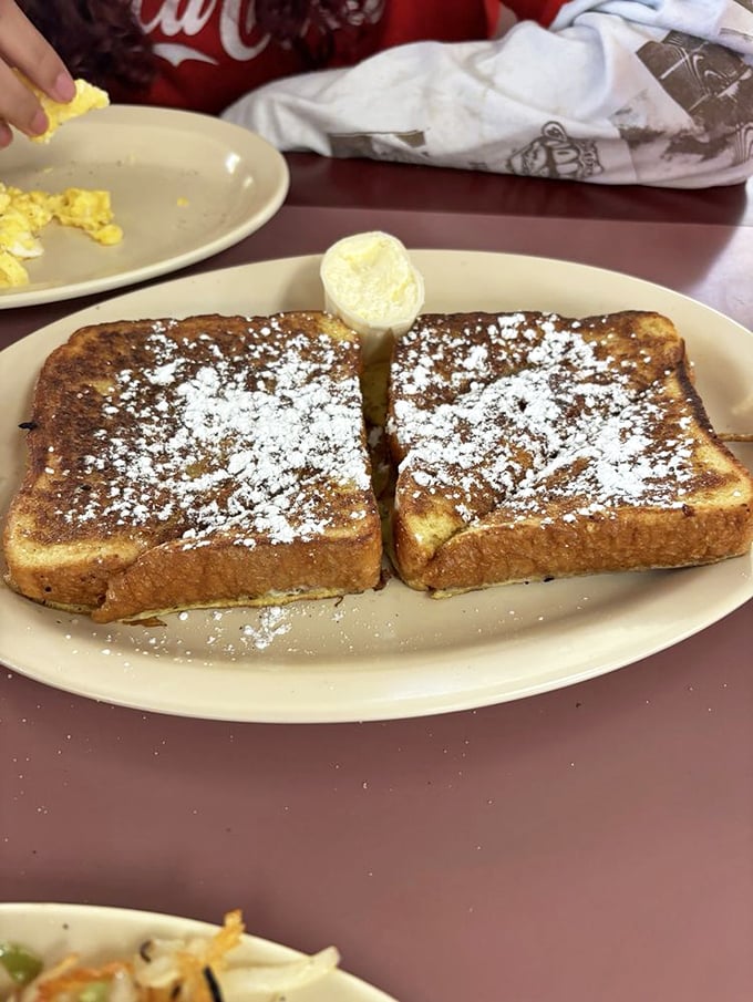 French toast dusted with powdered sugar and crowned with a dollop of butter&mdash;breakfast that successfully blurs the line between meal and dessert. 
