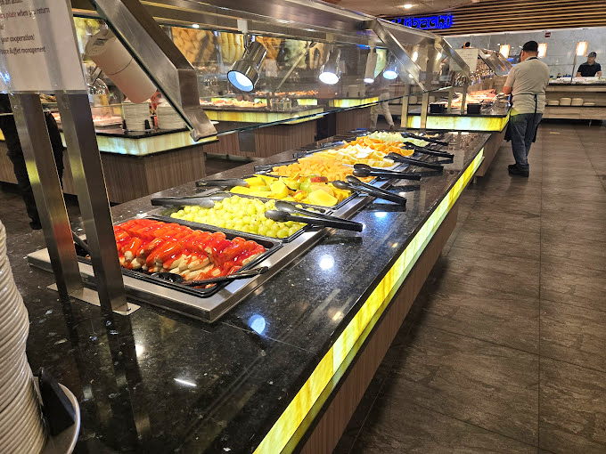 A rainbow of fruits and carefully arranged crab legs await their fate. The ice beneath the seafood whispers, "I'm keeping things fresh here."