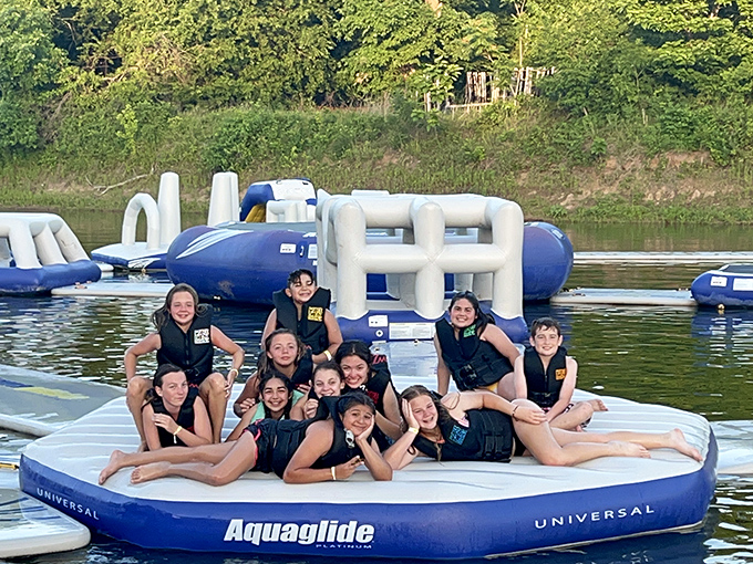 Squad goals achieved on floating platforms. These kids have mastered the art of conquering inflatable islands while making memories that will last forever.