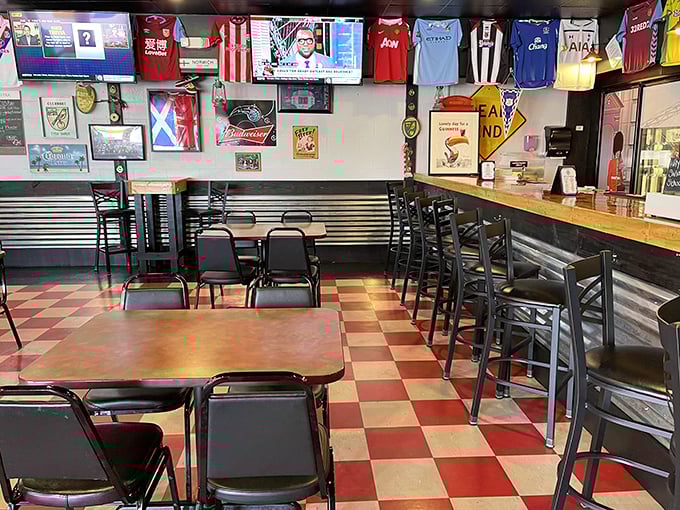 Soccer jerseys hang like battle flags above the dining room, silently cheering on your culinary journey through British pub fare.