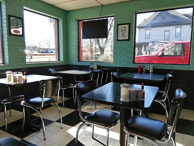 Chrome-edged tables, vinyl chairs, and large windows create the perfect stage for the daily theater of American life that unfolds in diners like this.