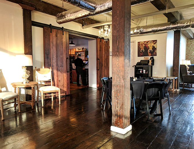 Sliding barn doors and exposed brick create an atmosphere where comfort meets sophistication, like blue jeans with a tailored jacket.