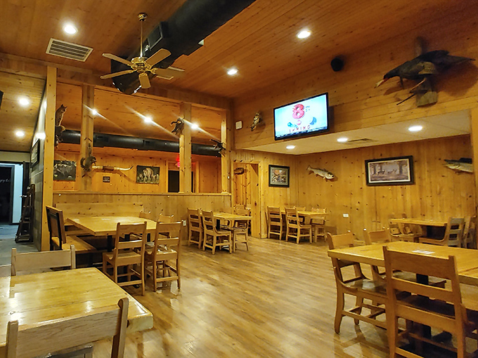 Honey-colored wood paneling creates the perfect backdrop for serious eating. Every mounted fish on the wall is silently judging your food choices.