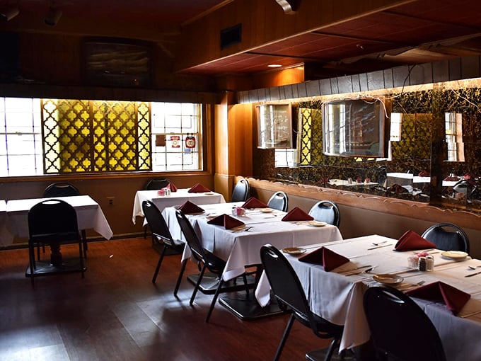 The latticed windows filter light onto white tablecloths, creating that rare dining atmosphere where conversations deepen and food somehow tastes even better.