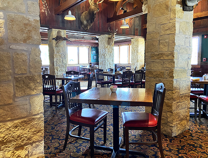 Stone columns and wooden tables create dining spaces that feel both spacious and intimate, like your favorite uncle's ranch house.