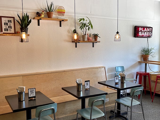 Plant-based paradise meets industrial chic with hanging cage lights that make even the succulents look impossibly cool.