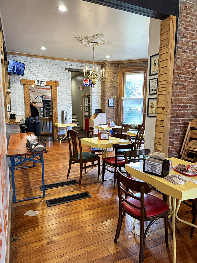 Yellow tables against exposed brick walls create a dining room that feels like your coolest friend's place—if that friend happened to be a barbecue savant.