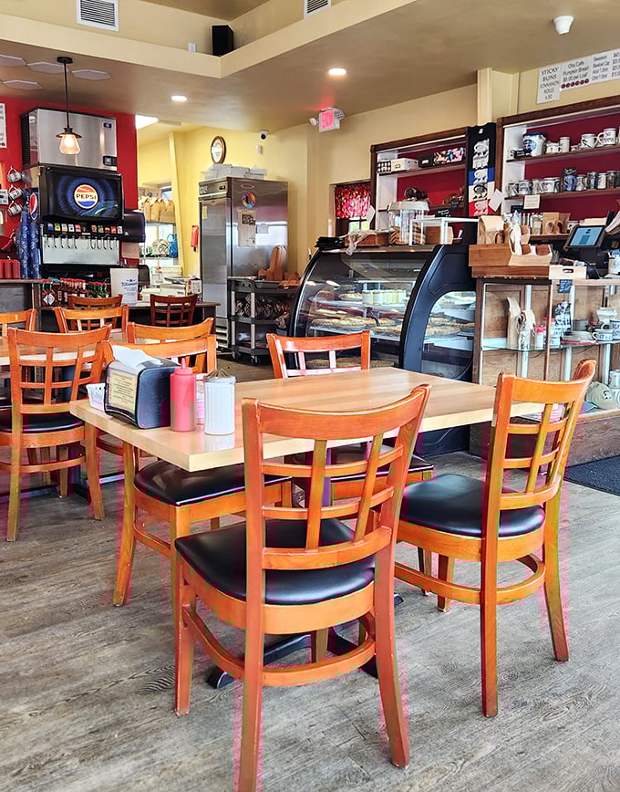 The bustling heart of Otis Cafe, where coffee flows freely and the display case tempts you with baked goods that would make your diet plan file for divorce.