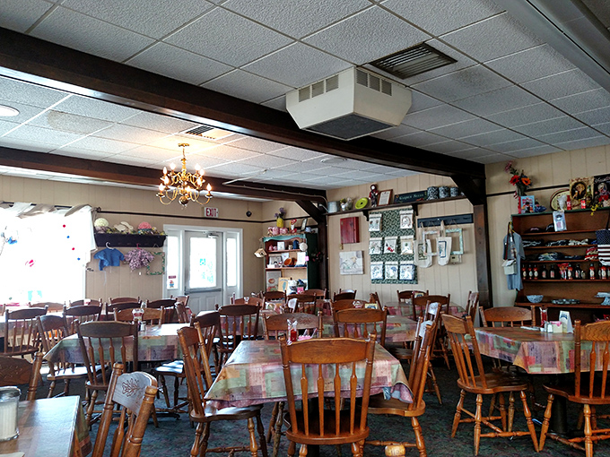 The dining room feels like stepping into 1975, where wood paneling, simple tables, and homey curtains create an atmosphere no designer could replicate.