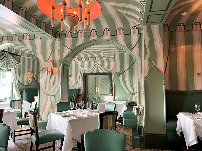 The dining room's striped wallpaper and elegant mirrors create the feeling you've stepped into a Wes Anderson film where calories simply don't count.